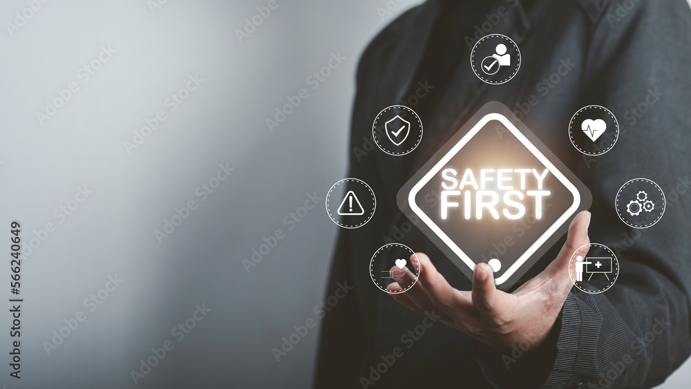 ..Work safety concept. Businessman hold on Safety first text . Safety ...