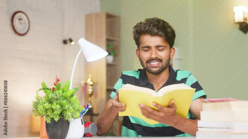 student got frustrated while reading before exam night at home ...