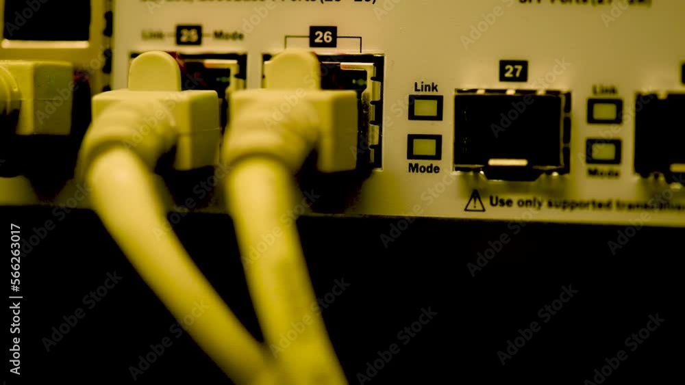 blinking LED lights in a server rack with RJ45 and fiber optic cable ...