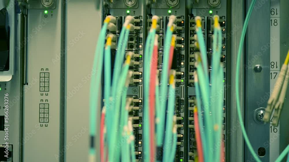 blinking LED lights in a server rack with RJ45 and fiber optic cable ...