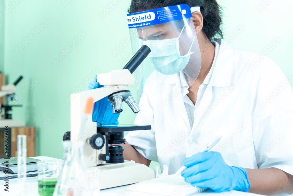 Indian Scientist man look into Microscope research in science ...