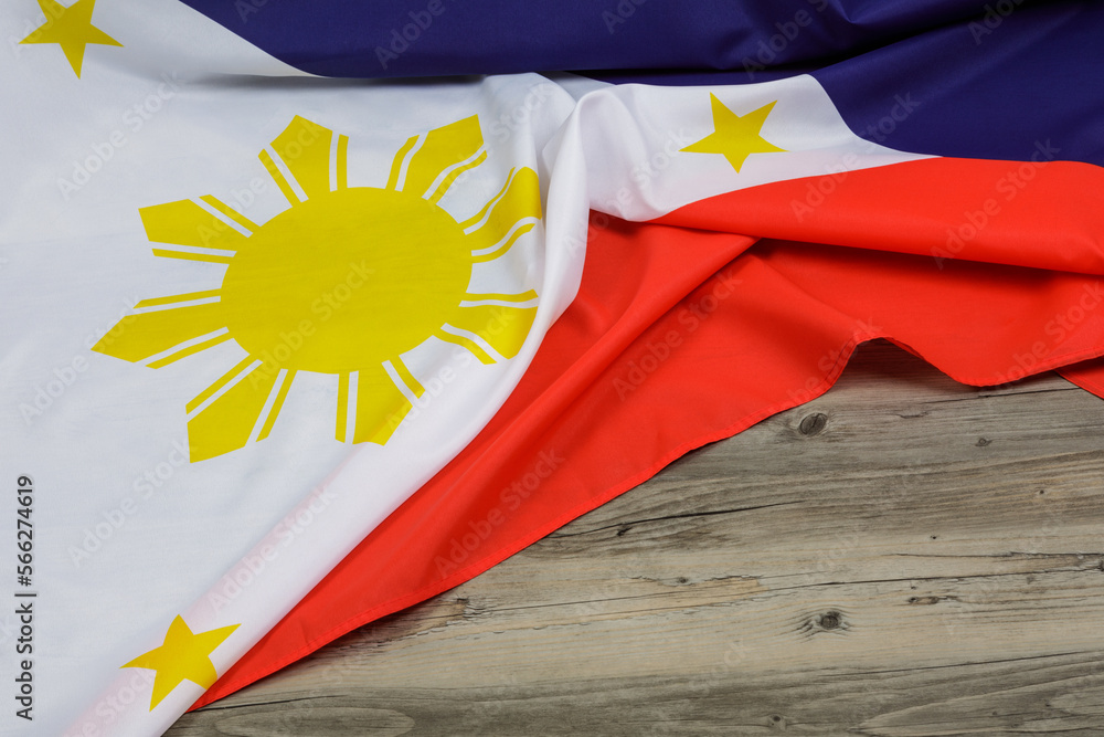 Philippine Flag draped over a wooden background Stock Photo | Adobe Stock