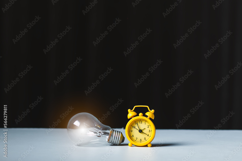 light bulbs with clock alarm on the table, concept time manage of good ...