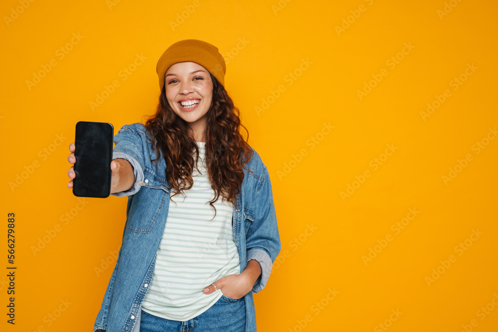 Young girl showing black screen smartphone at camera while standing ...