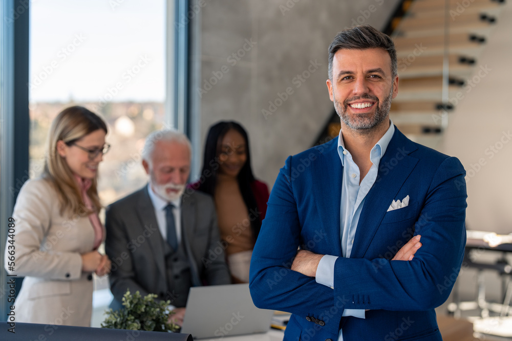 Portrait of smiling confident businessman leader wearing suit looking ...