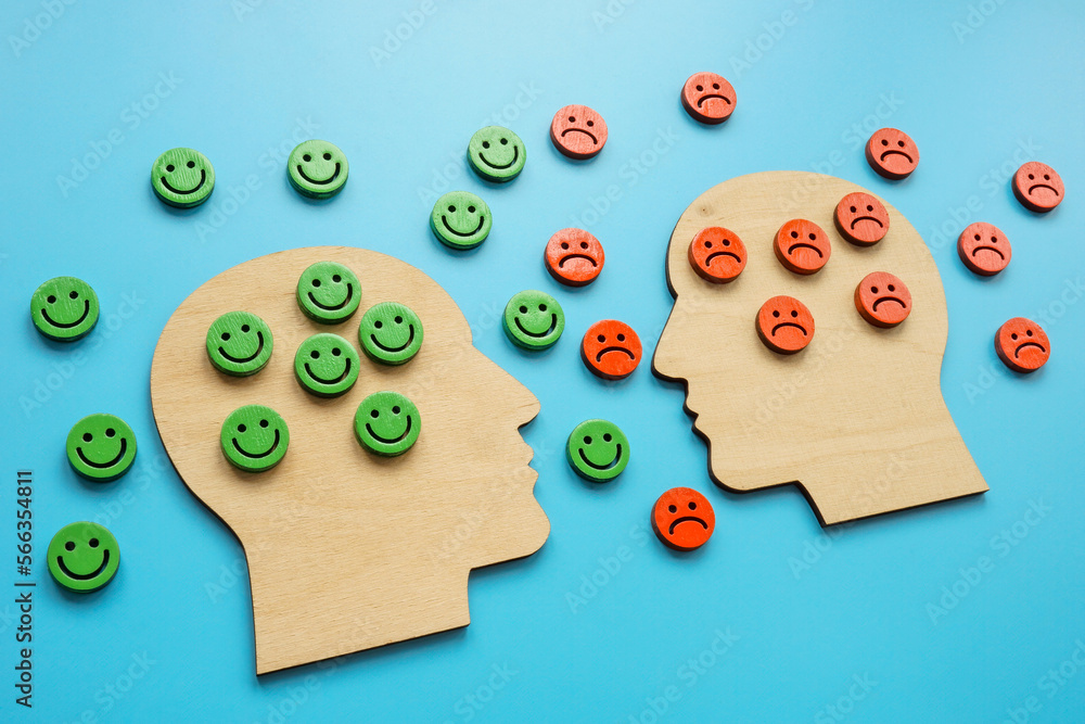 Heads with negative and positive emoticons. Resilience and emotions ...