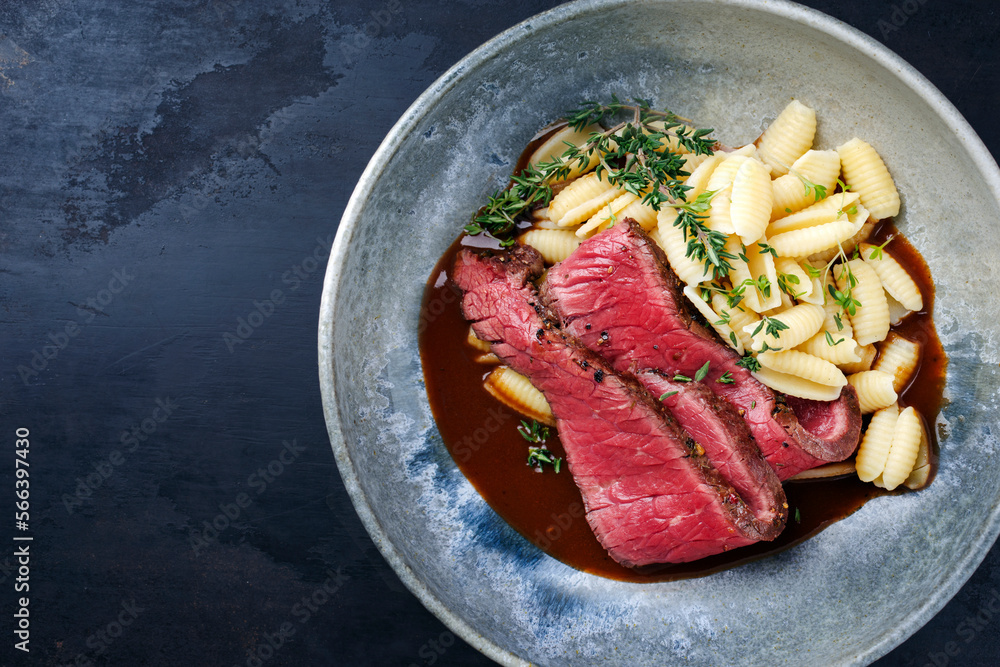 Traditional Italian chianina sliced roast beef with gnocchetti sardi ...