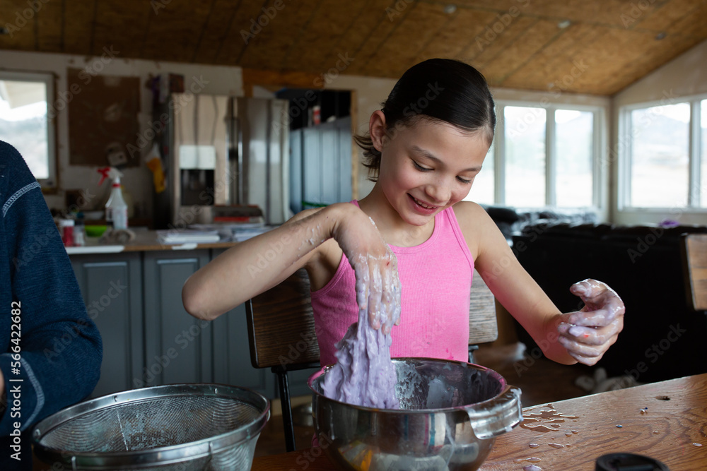 Tween girl playing with slime she just made Stock Photo | Adobe Stock