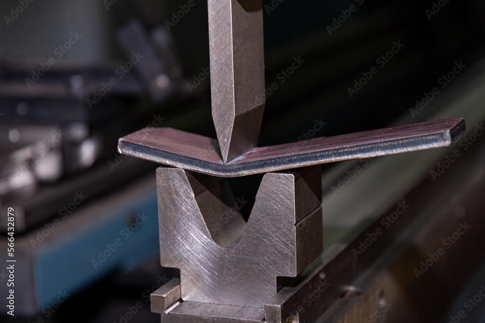 Metal bending. Bending of metal using a v-shaped matrix and a punch ...