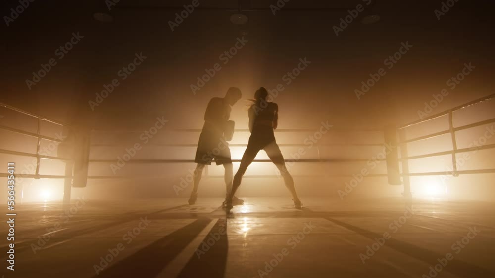 Female athlete defensing in boxing club. Woman and her coach training ...
