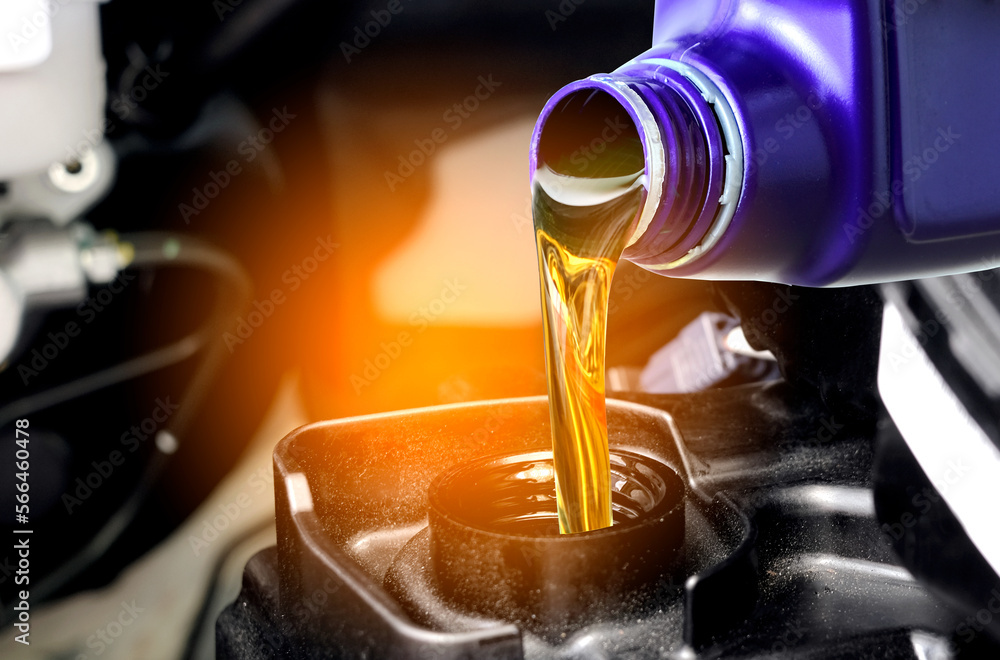 Refueling and pouring oil quality into the engine motor car ...