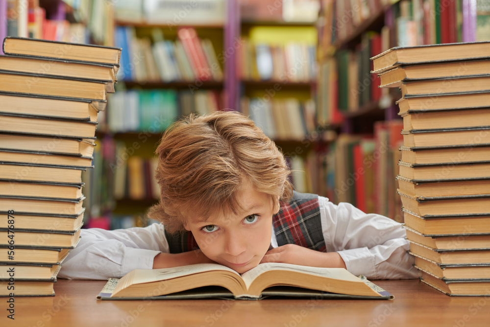 boy in library Stock Photo | Adobe Stock