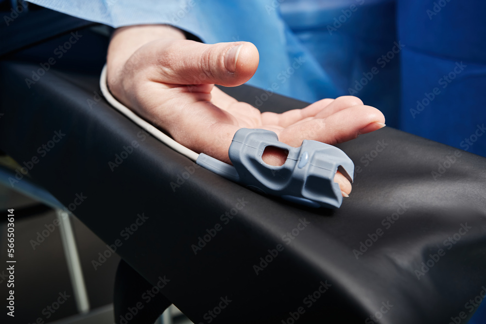 Pulse oximeter on patient's finger for detection of oxygen saturation ...