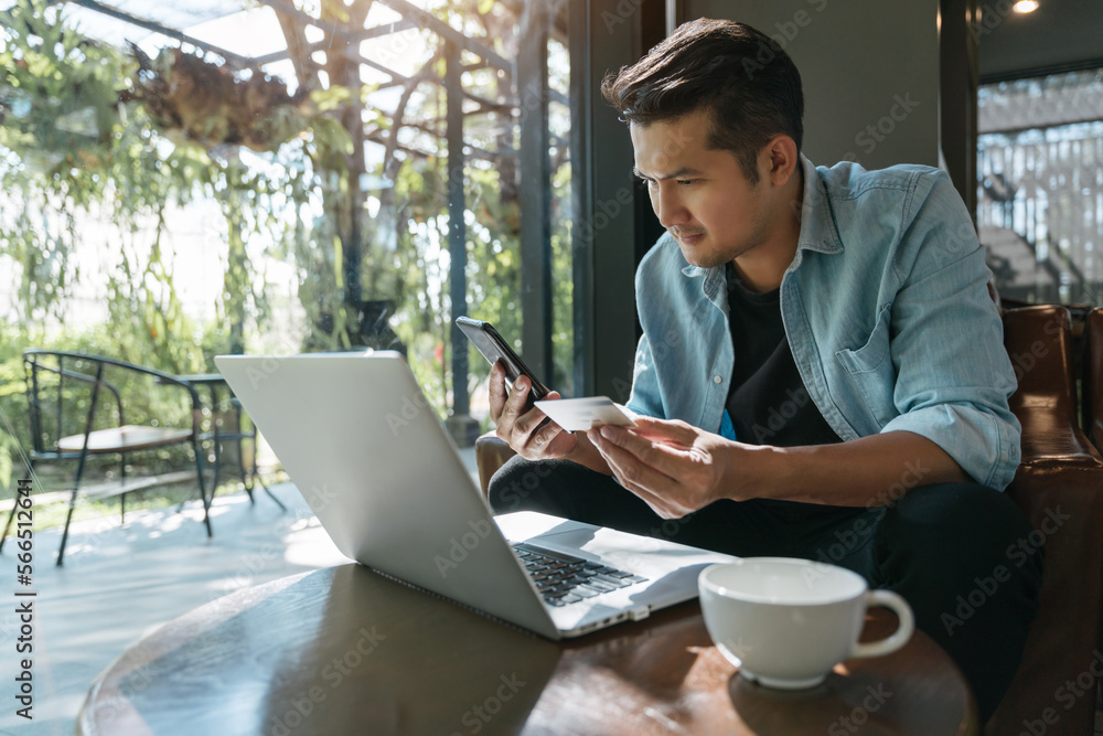 Asian man hands using smartphone and laptop computer for online ...