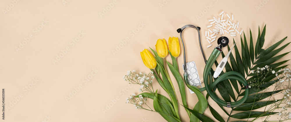 Bouquet of flowers and stethoscope on a beige background, a place for ...