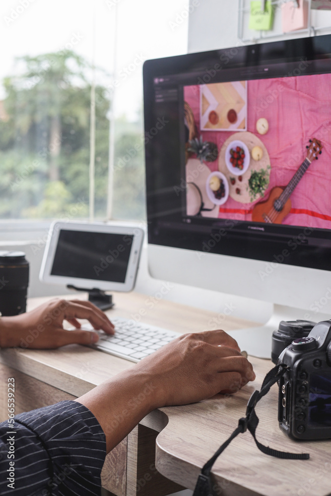 Professional photographer or editor sitting and editing picnic theme ...