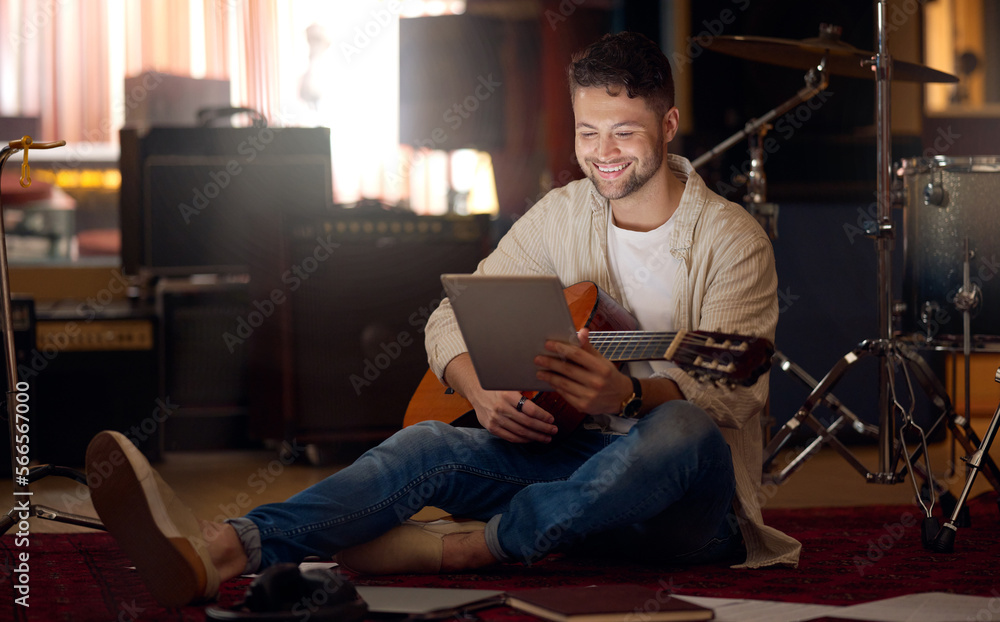 Digital tablet, guitar and man in a recording studio for music ...