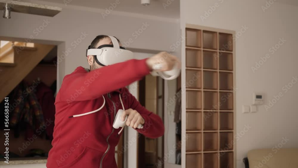 Man At Home Wearing Virtual Reality Headset Holding Gaming Controllers ...