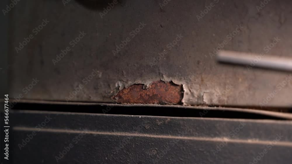 Spot of rust on a gray metal part. Corrosion from damage and ...