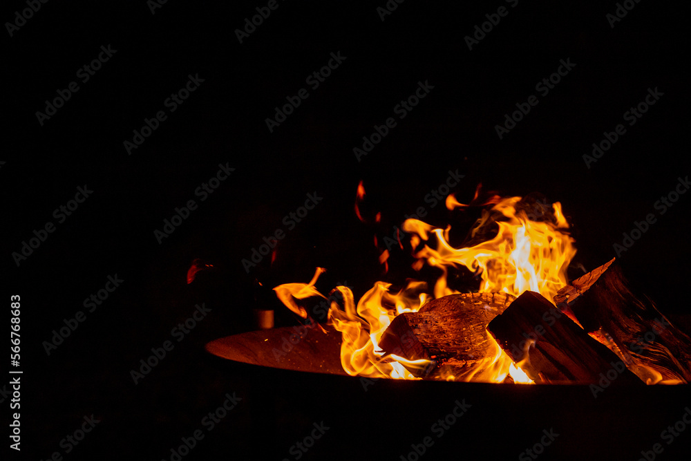 fire plate with stack of wood.Glowing ash and burning wood in an iron ...