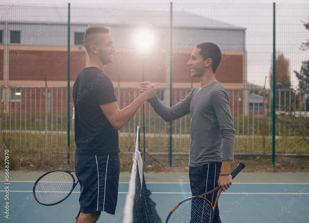 Side view of friends holding hands while playing badminton Stock Photo ...