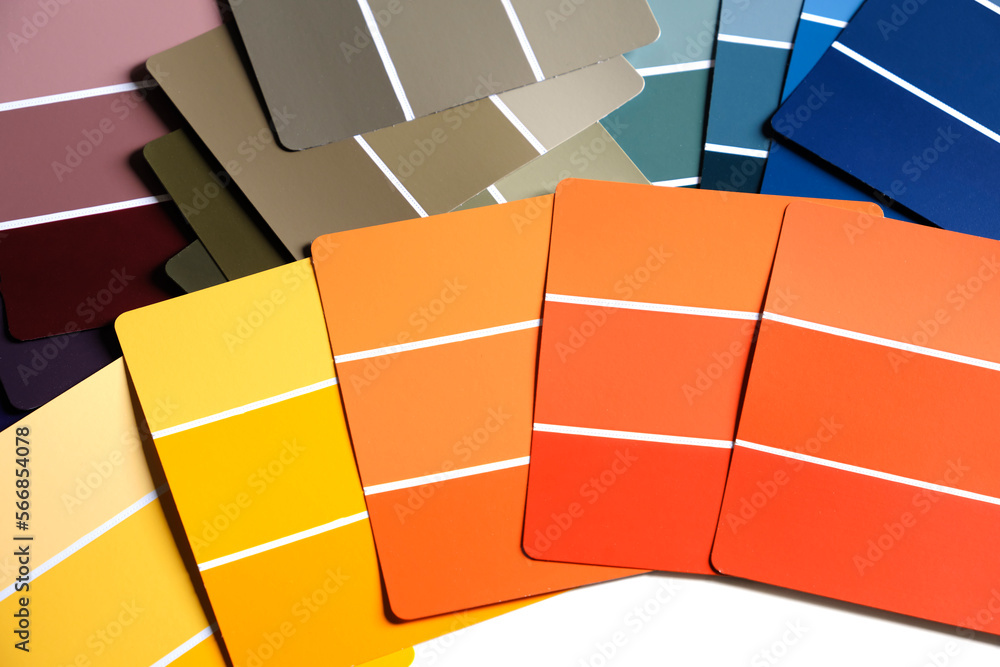 Color sample swatches on a table or desk. Swatches are in various ...