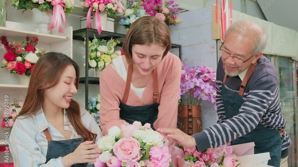 Flower shop team, Young beautiful female florist workers with old owner ...