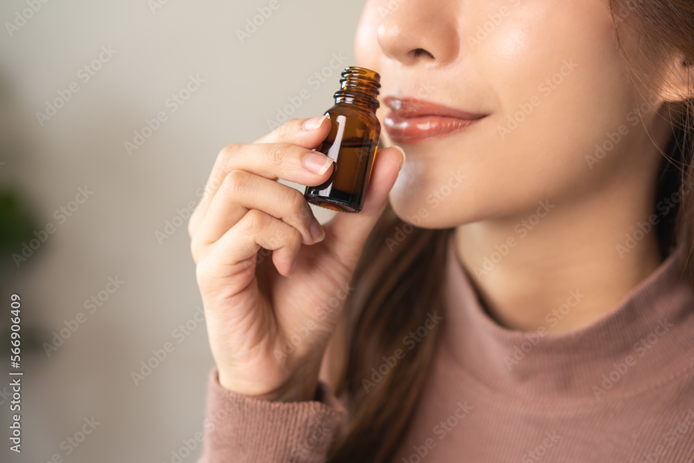 Aromatherapy, attractive asian young woman hand holding bottle of ...