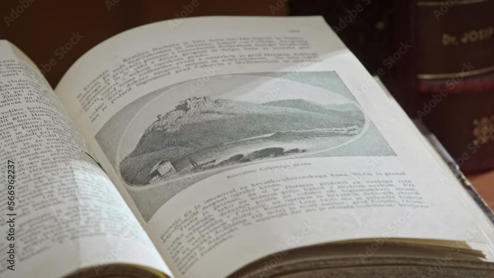 Close up of an open book with a text and a drawing of a castle on the ...