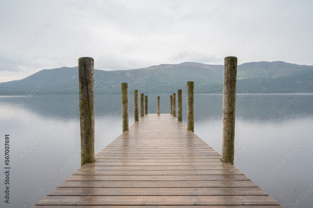 Derwentwater Jetty boat landing with wooden posts and long exposure to ...