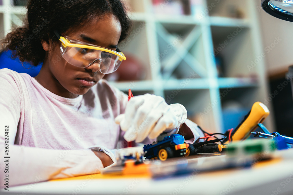 Smart Young African American Schoolgirl is Studying Electronics and ...