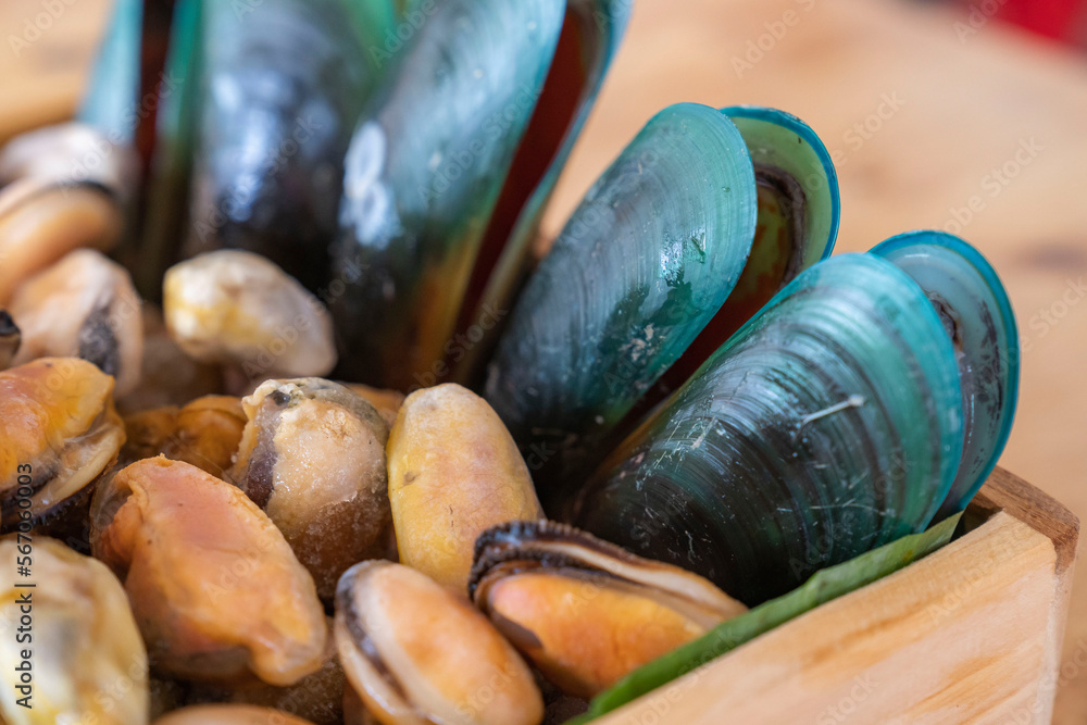 Box with a lot of fresh healthy seafood mussle with and without shell ...