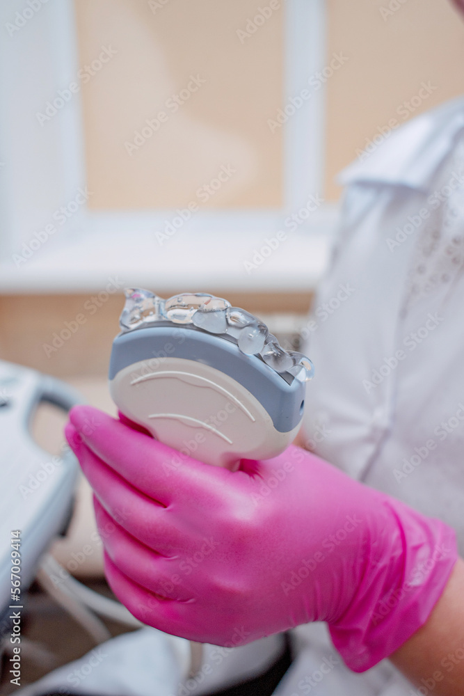 Probe for ultrasound diagnostics close-up. The doctor holds in his ...