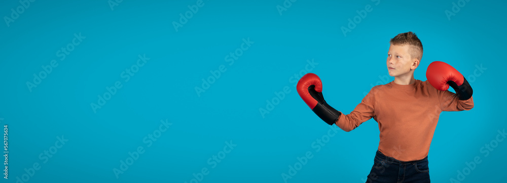 Preteen Boy Wearing Boxing Gloves Making Fighter Posture And Looking ...