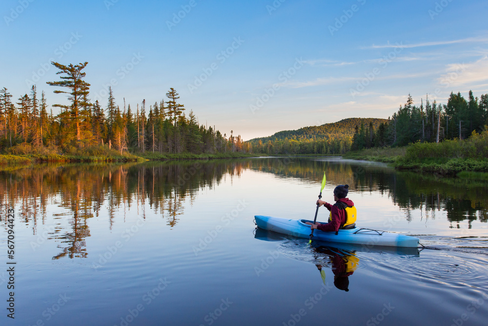 Person kayaking on St. Regis River in Adirondack Park, New York, USA ...