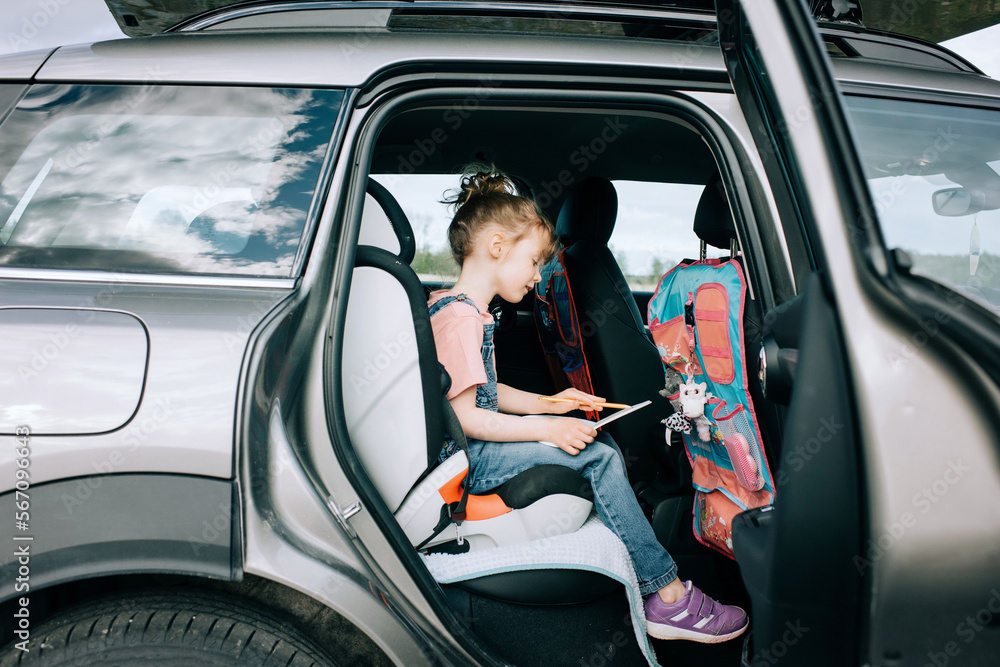 girl sitting in the car drawing pictures feeling happy Stock Photo ...