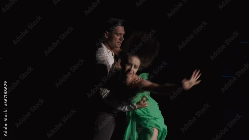 Dancer performs left pirouette and bends backwards with support of her ...