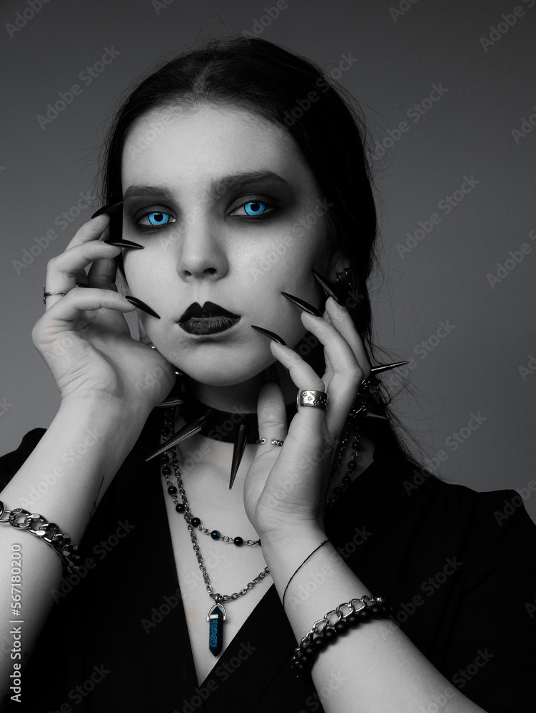 Brunette in a gothic look with blue eyes long nails black and white ...