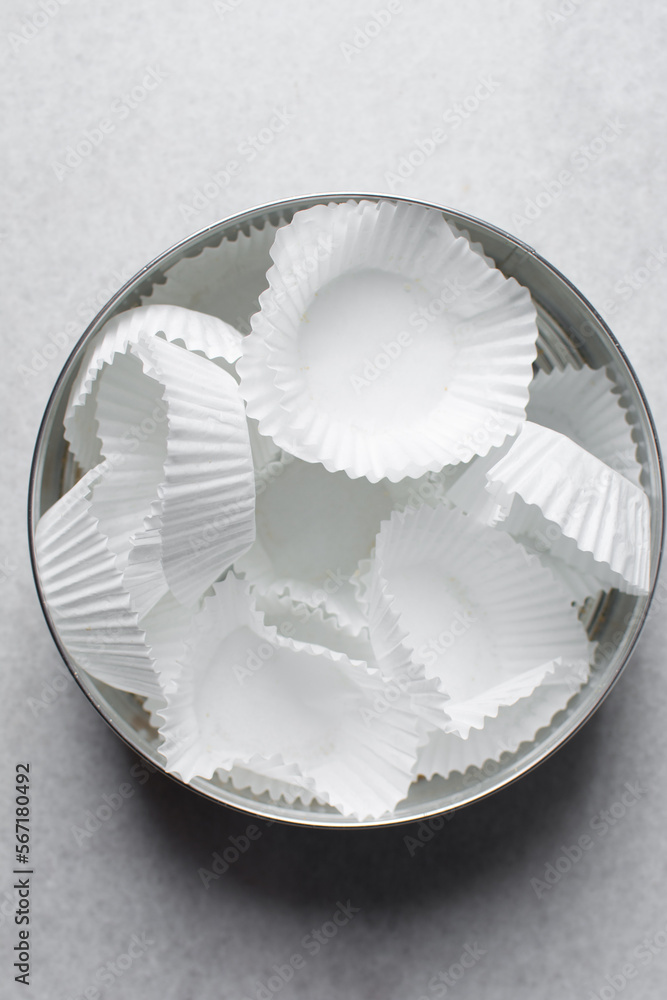 An empty tin of danish cookies with only the wrappers inside, white ...