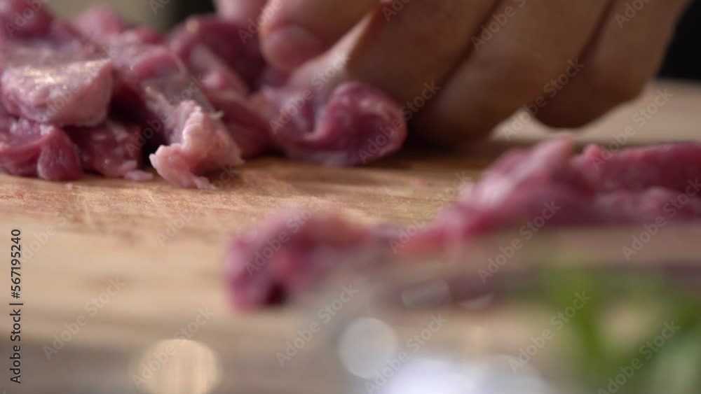 Chef butcher expertly wields his sharp knife, deftly slicing through ...