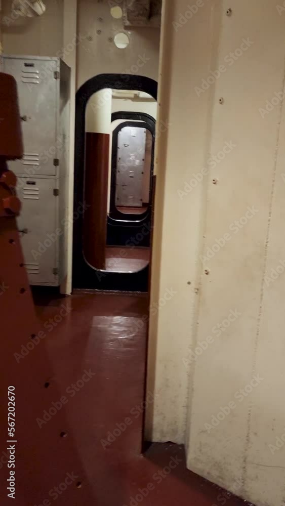 footage of inside the lower decks of the USS Alabama along the walkways ...