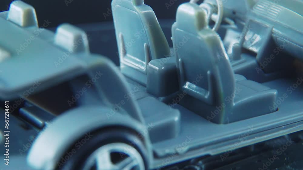 A little model metal sample skeleton of a car on a rotating stand with ...