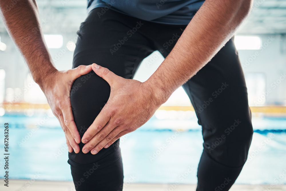 Hands, knee injury and swim instructor holding his joint in pain with a ...