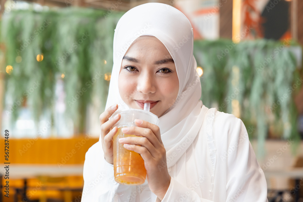 Happy Muslim woman drinking delicious halal boba tea aka bubble tea or ...