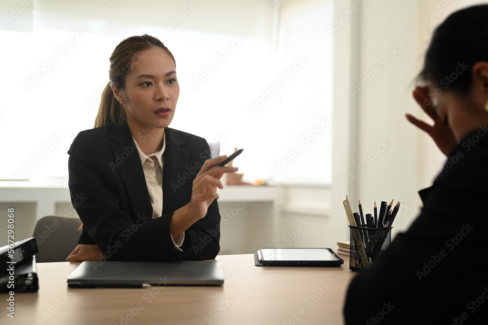 Furious female manager scolding frustrated young employee. Emotional ...