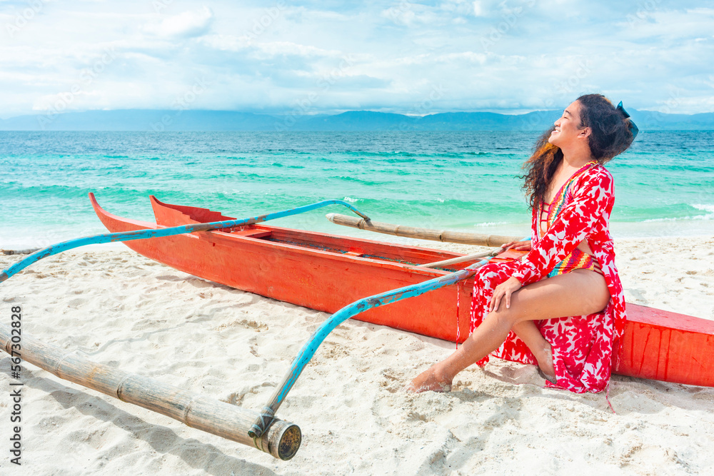 Transgender woman posing in colorful swimwear,on a boat,White Beach ...