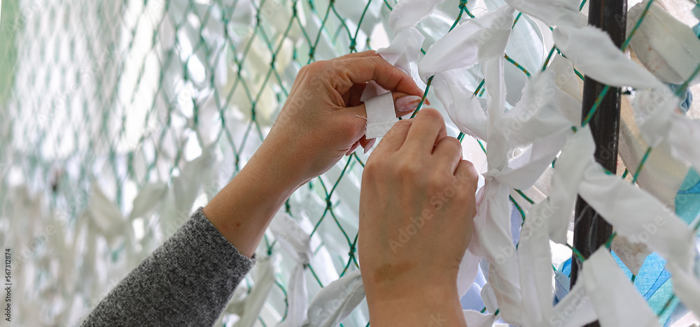 female hands weaving camouflage net for soldiers, war theme and ...