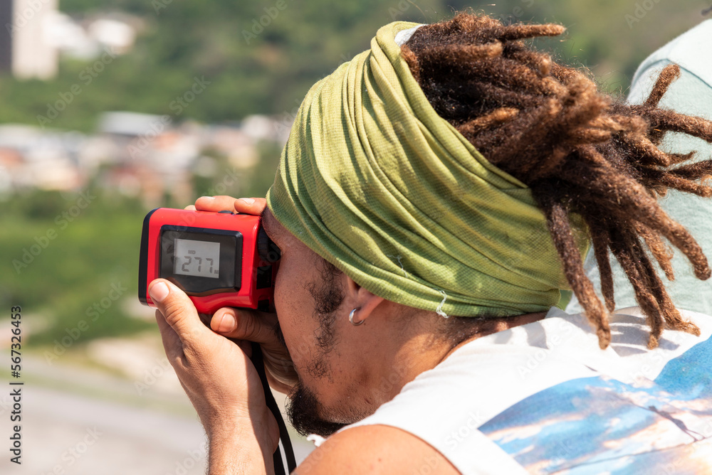 Highliner measuring distance with laser meter, Olympic Village, Barra ...