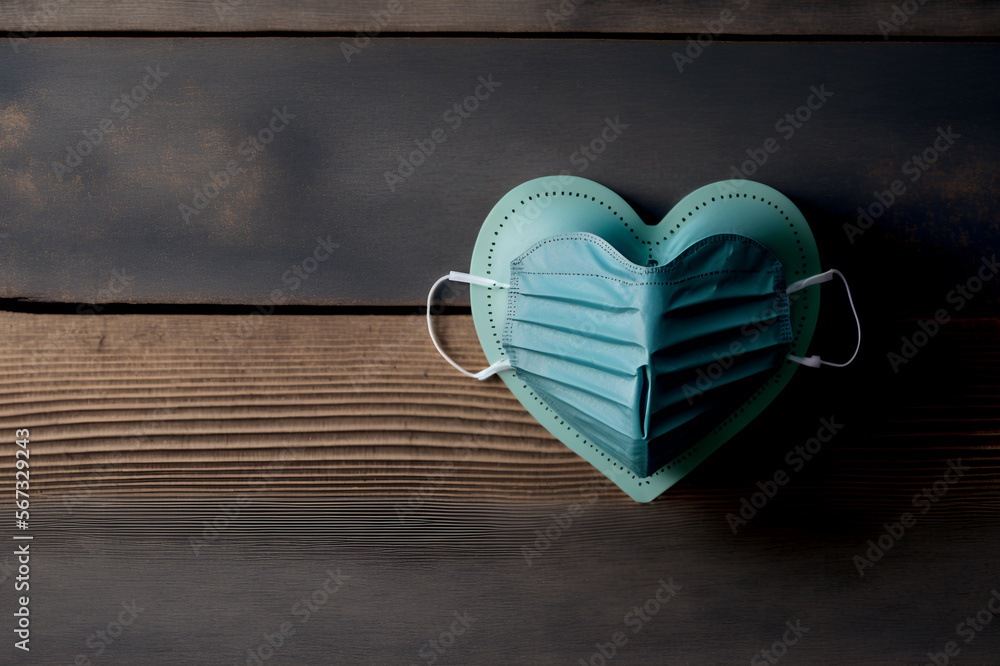 heart on the wood. love for protection with a heart made of masks. This ...