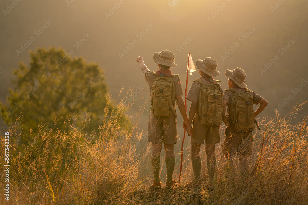 Asian scout leader stands and points out the long-distance targets for ...